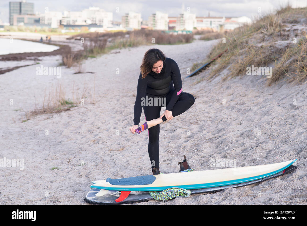 Female surfer preparing on beach Stock Photo - Alamy