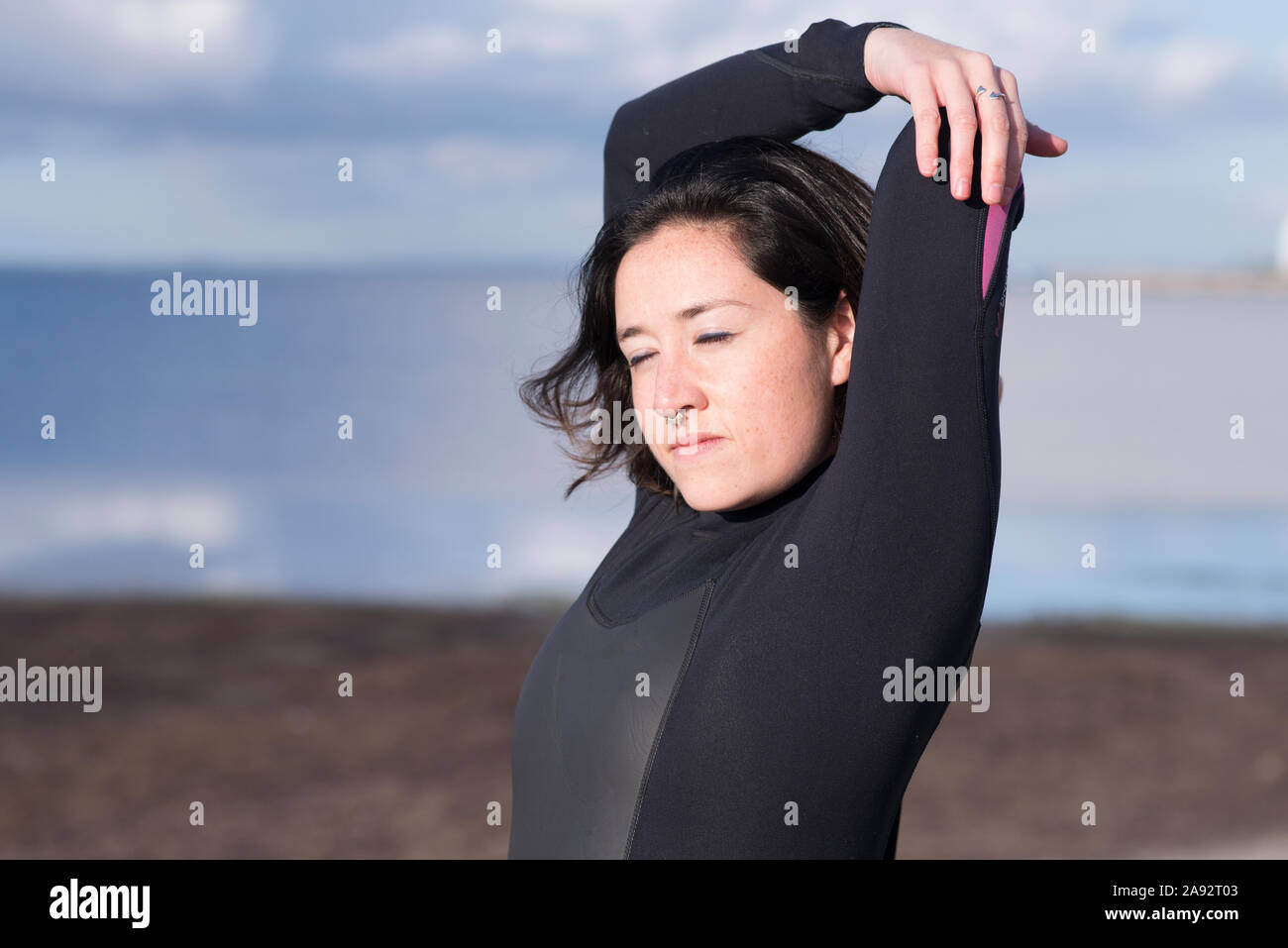 Female surfer stretching Stock Photo - Alamy