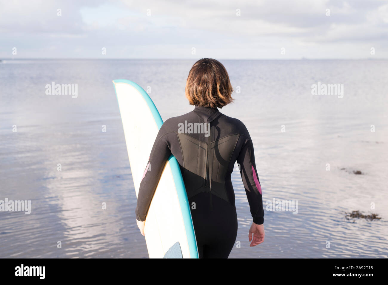 Female surfer with surfboard Stock Photo - Alamy