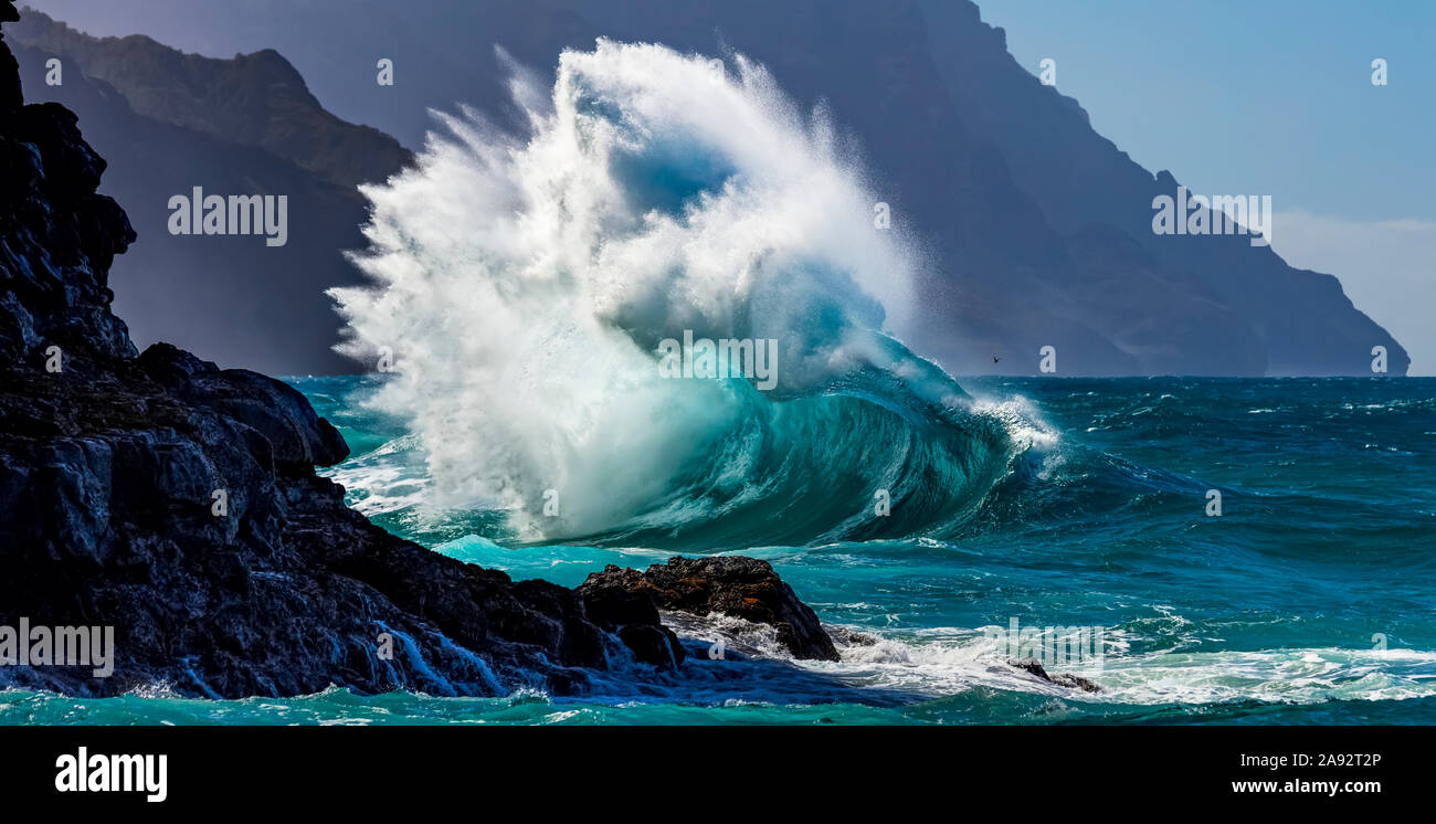 Large ocean wave crashes into rock along the Na Pali Coast; Kauai ...