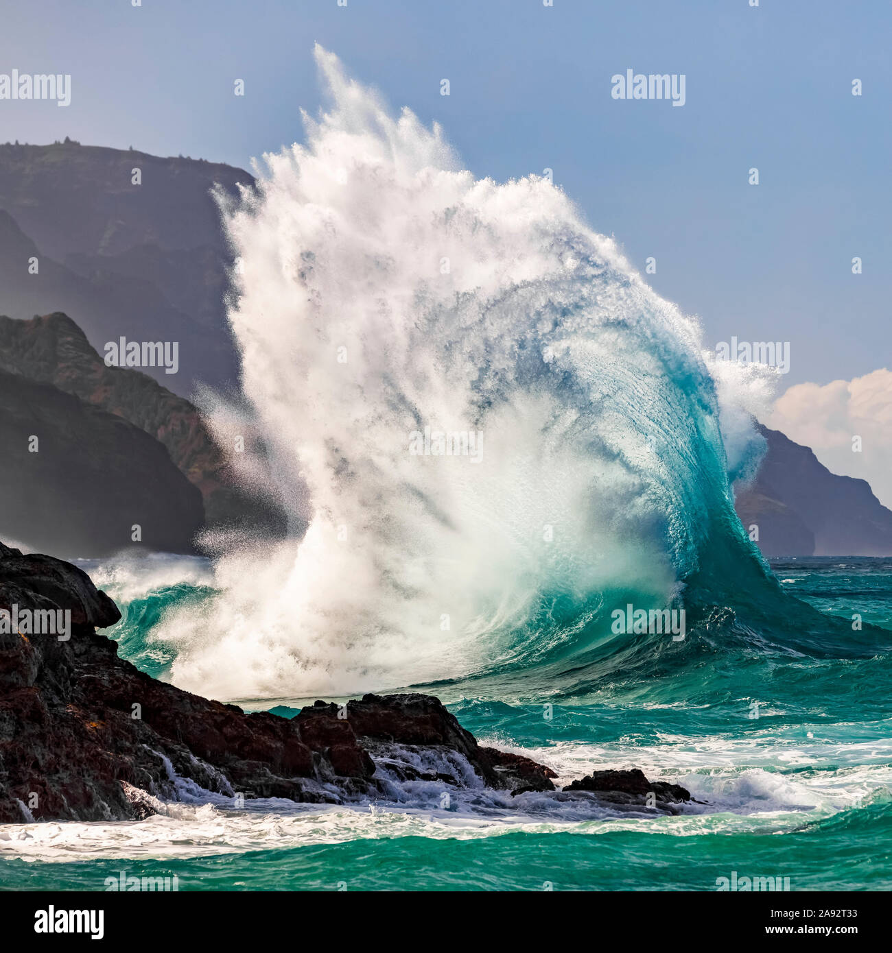 Large ocean wave crashes into rock along the Na Pali Coast; Kauai ...