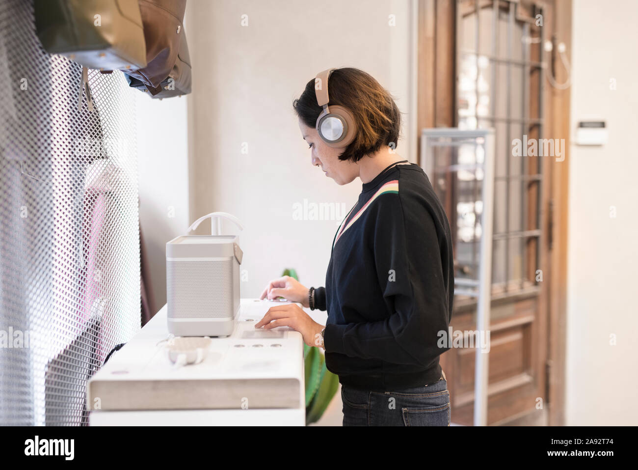 Woman listening to music while working Stock Photo - Alamy