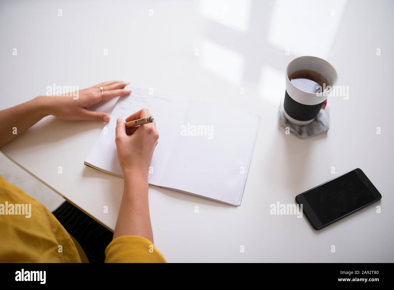 Writing in diary Stock Photo - Alamy