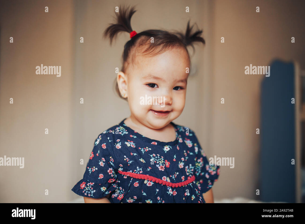 Asian baby look at camera and smile after she stop crying at home Stock Photo - Alamy