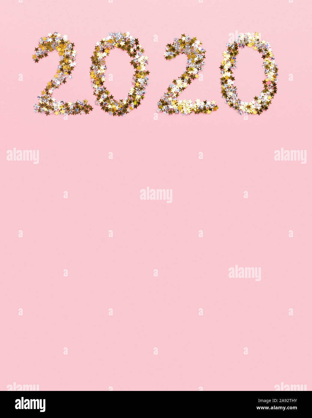 Big numbers of gold confetti on pink background Stock Photo - Alamy