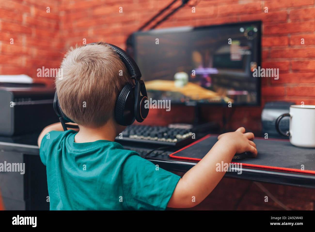 little boy playing games on computer Stock Photo - Alamy