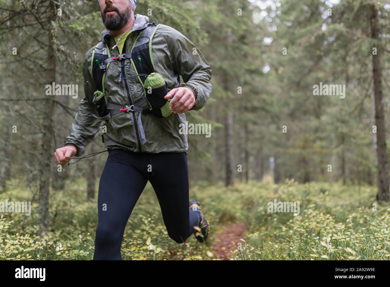 Man running in forest Stock Photo - Alamy