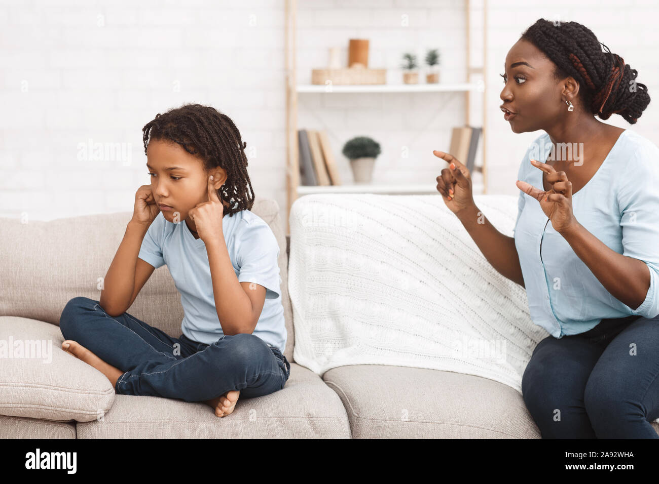 African-american mother telling off her daughter closing ears Stock ...
