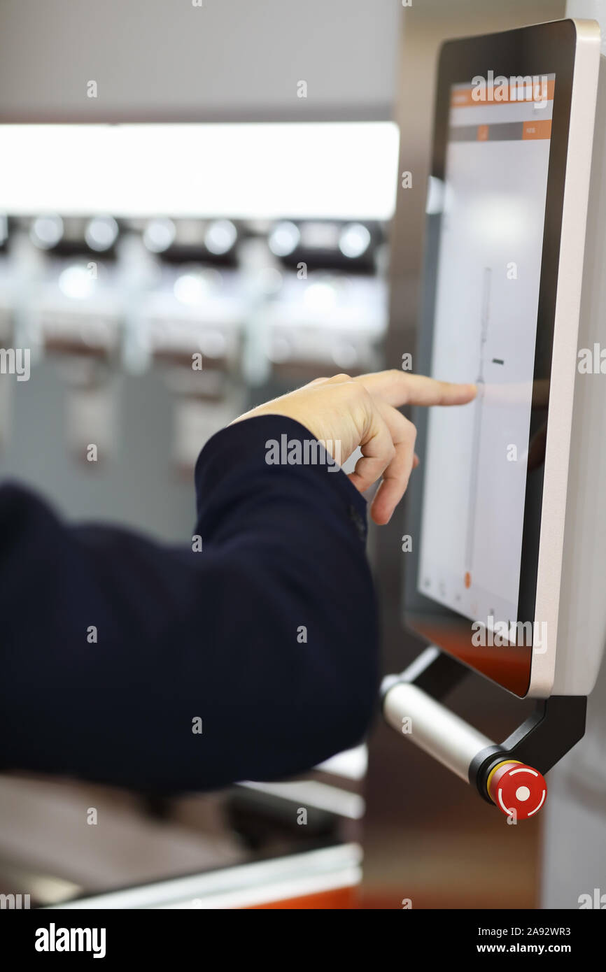 Engineer working with touchscreen control panel of modern automated ...