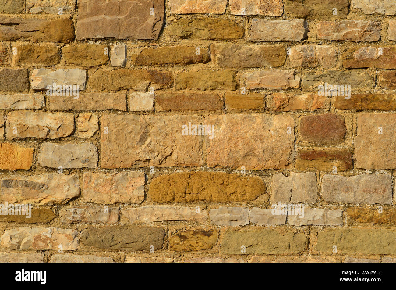 Old medieval yellow stone block wall as background Stock Photo - Alamy