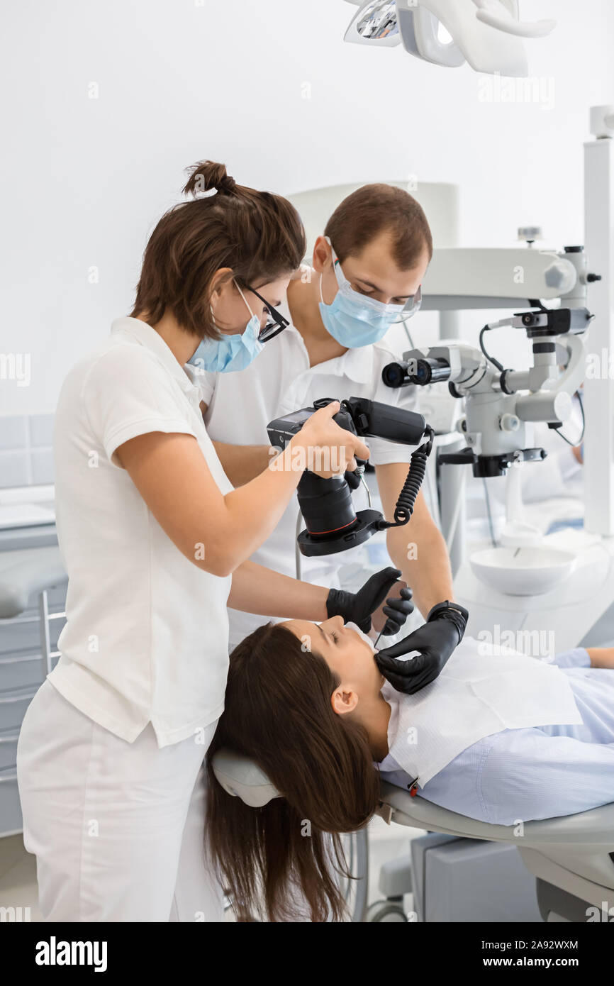 Shot of professional dentist taking photo of patient teeth Stock Photo ...