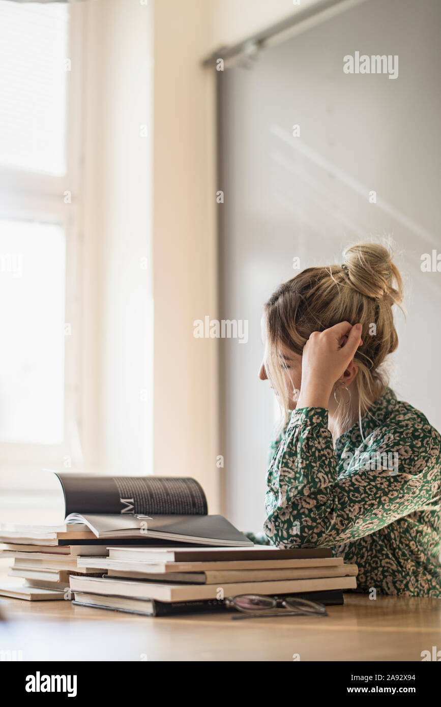 Woman reading books Stock Photo - Alamy