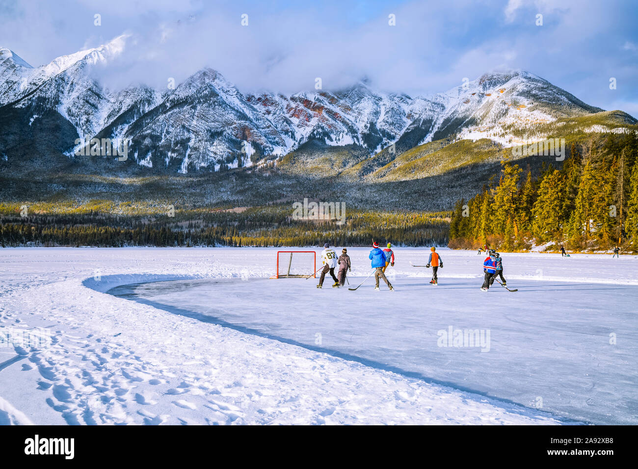 Frozen Pyramid Lake with kids playing hockey on a cleared ice rink in ...