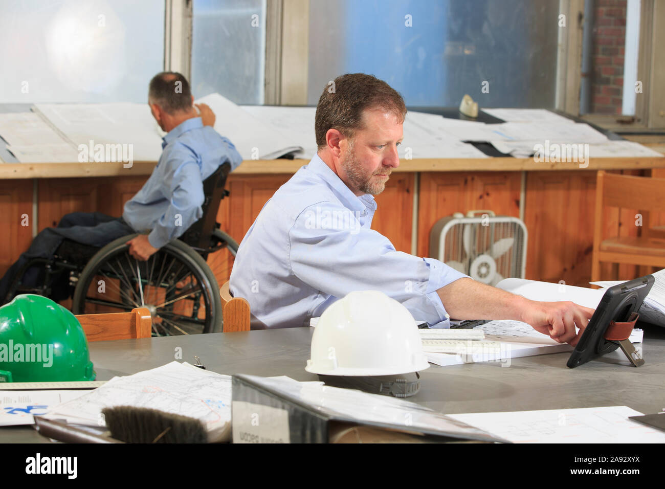 Two project engineers, one with a Spinal Cord Injury in a wheelchair ...