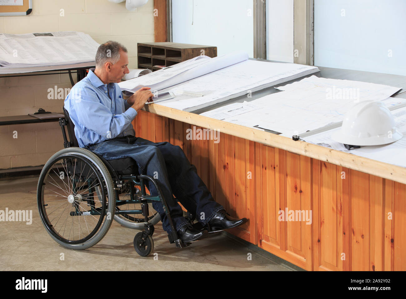 Project engineer with a Spinal Cord Injury in a wheelchair using a ...