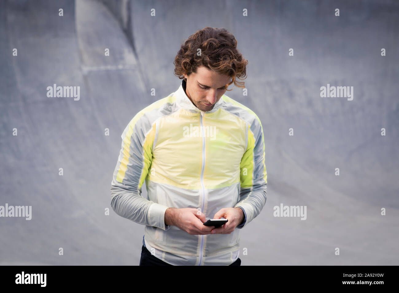 Man in sport clothes checking phone Stock Photo - Alamy