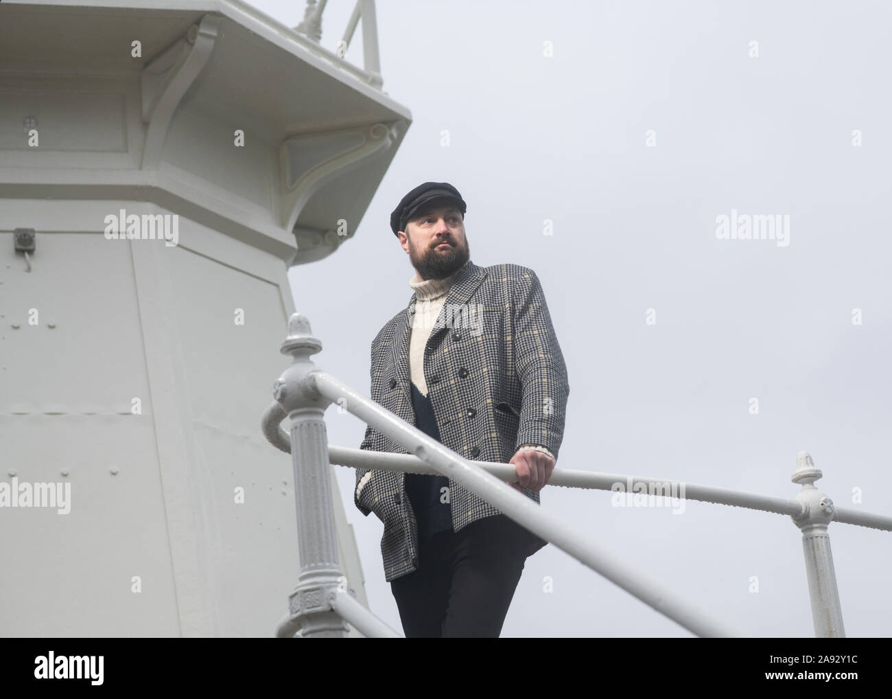 Man standing on lighthouse Stock Photo - Alamy