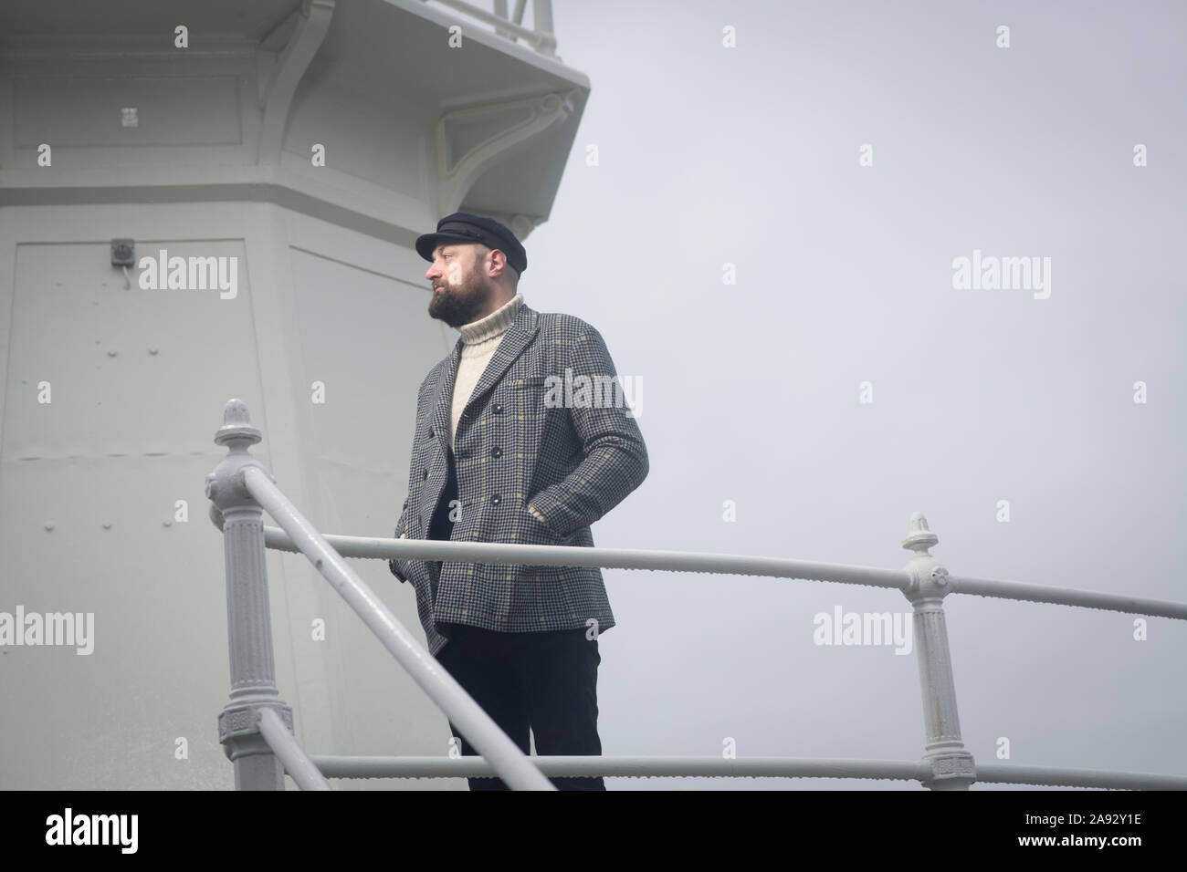Man standing on lighthouse Stock Photo - Alamy