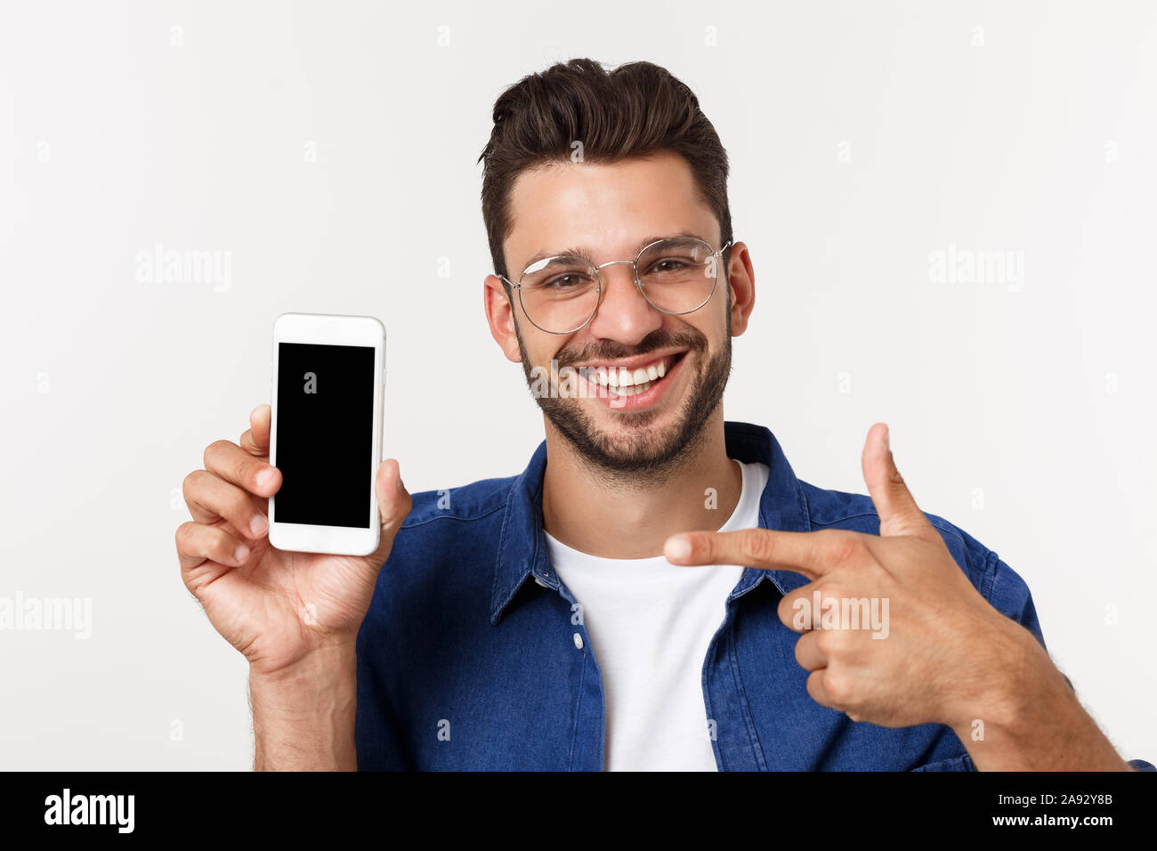 Young man showing his brand new smart phone isolated on white Stock ...