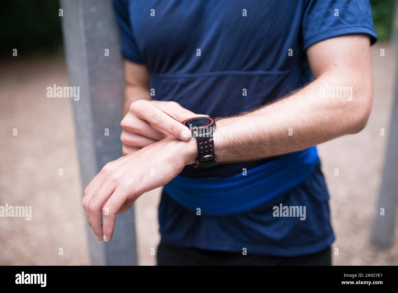 Man checking fitness watch Stock Photo - Alamy