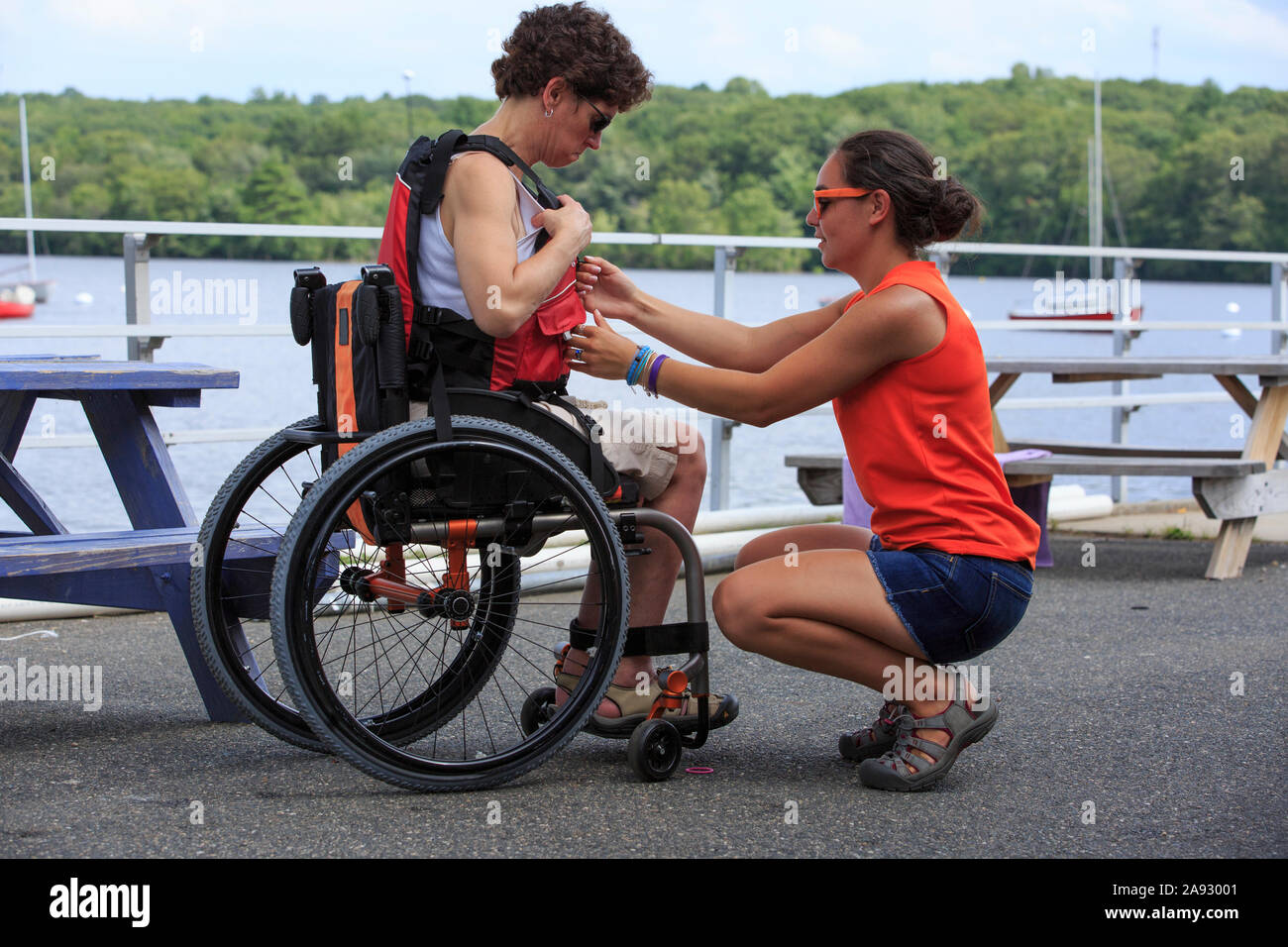 Woman with a Spinal Cord Injury being helped by an instructor to use a ...