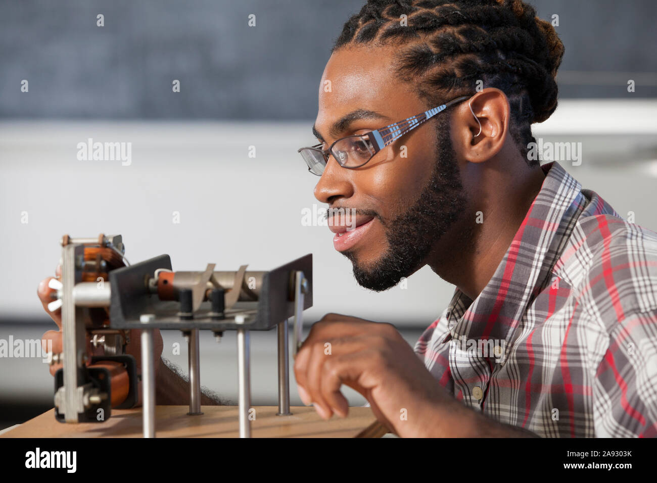 Student who had Spinal Meningitis with a hearing aid, working on an ...