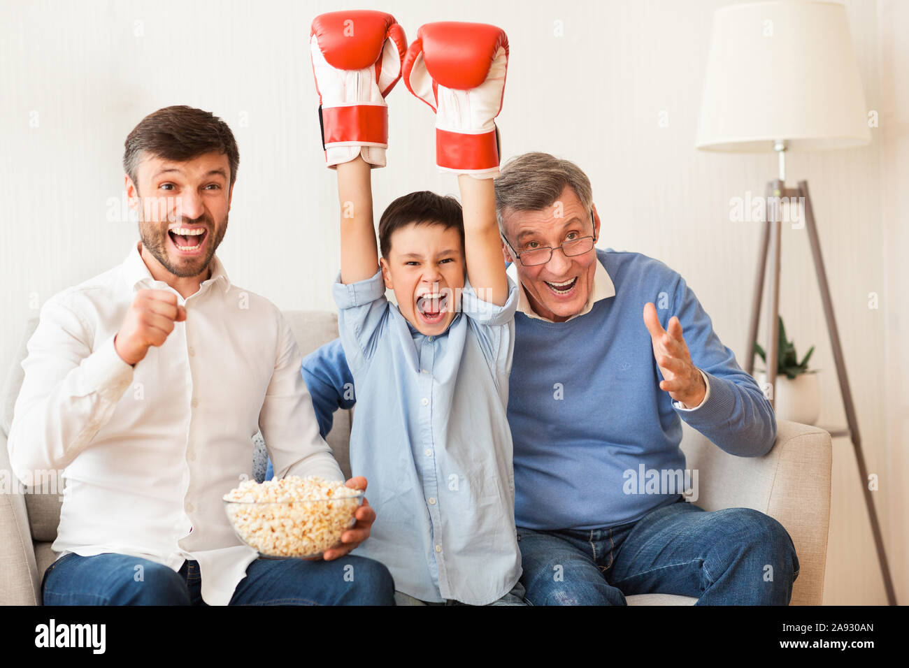 Boy, Father And Grandfather Watching Boxing Match On TV Indoor Stock ...
