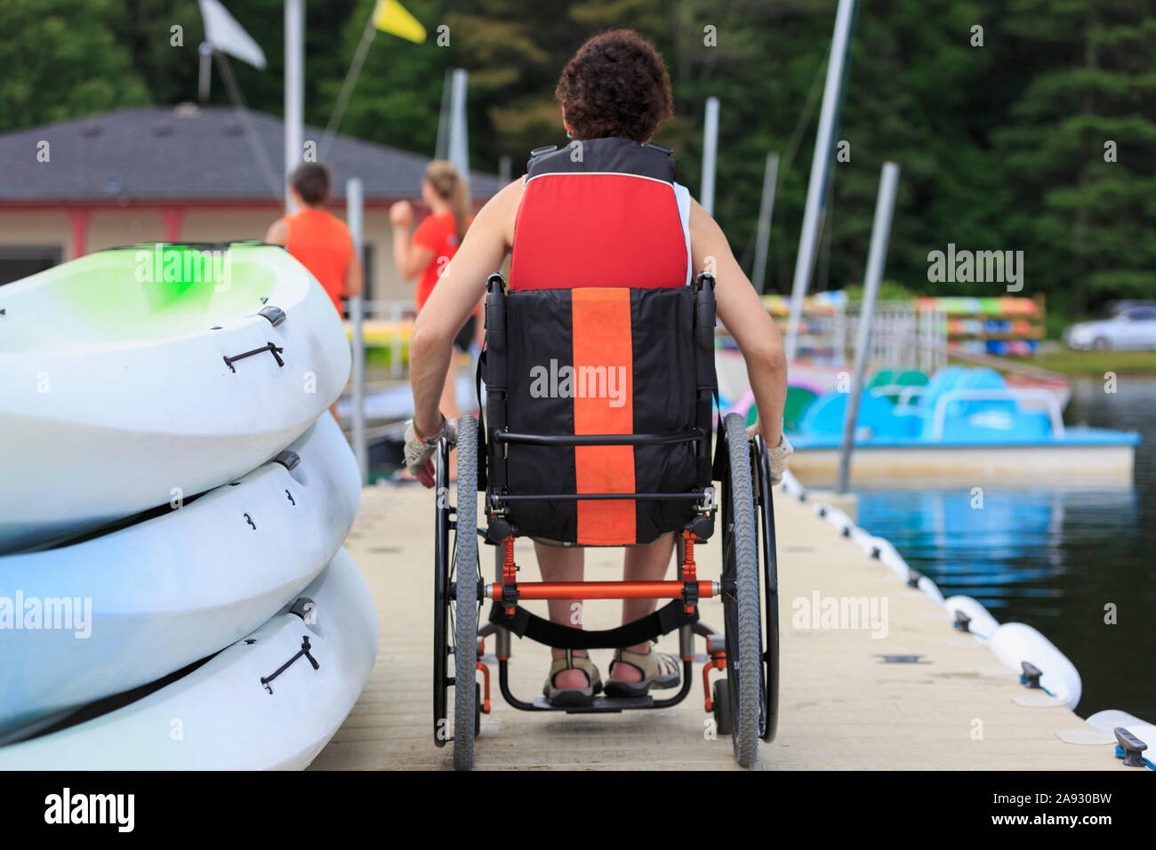 Woman with a Spinal Cord Injury in a wheelchair on a boat dock Stock ...