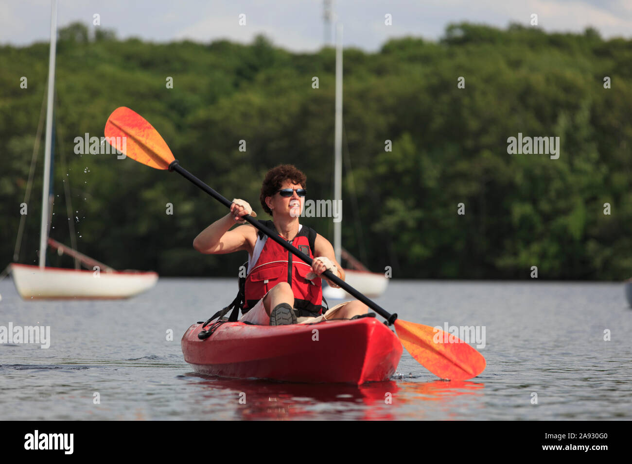 Woman with a Spinal Cord Injury learning how to use a kayak Stock Photo ...