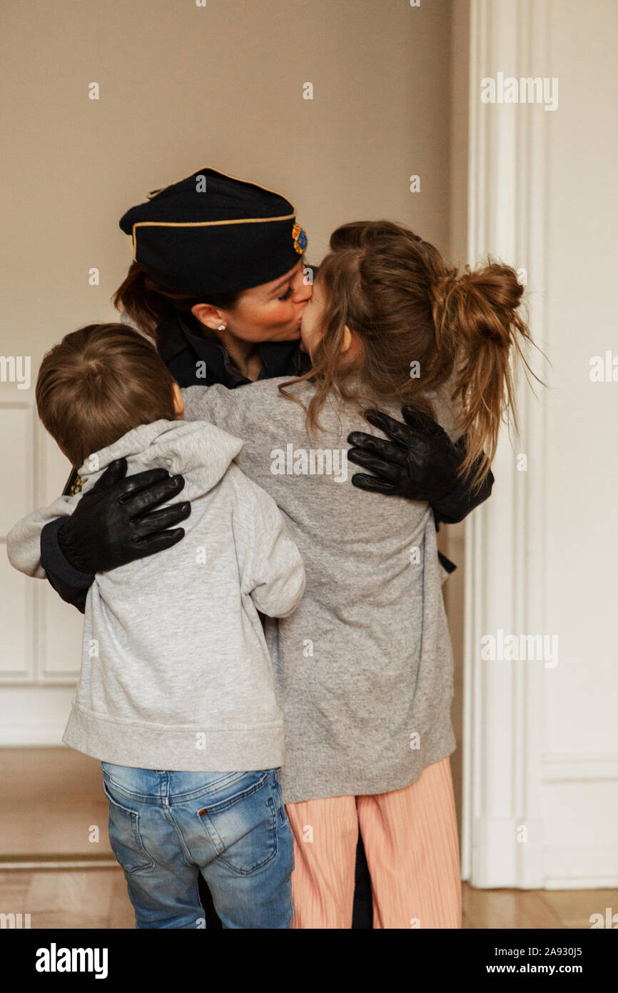 Police woman hugging children Stock Photo - Alamy