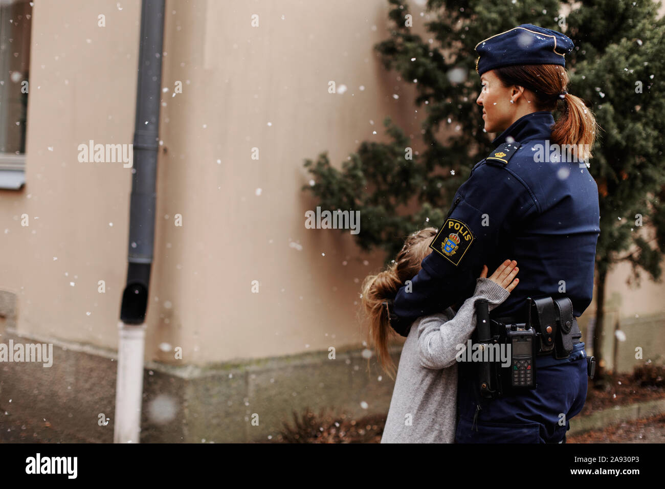 Police woman hugging daughter Stock Photo - Alamy