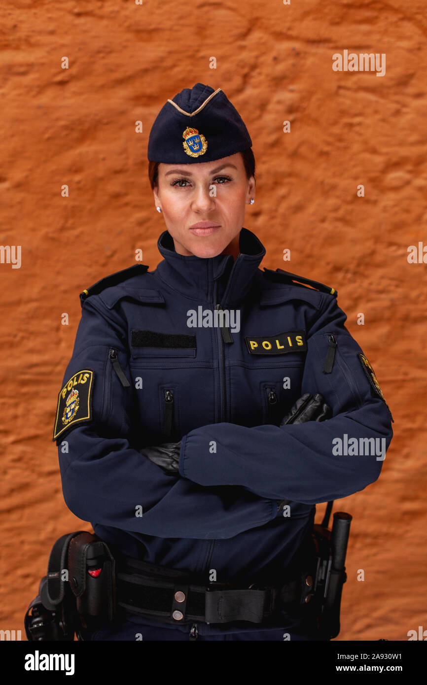 Police woman looking at camera Stock Photo - Alamy