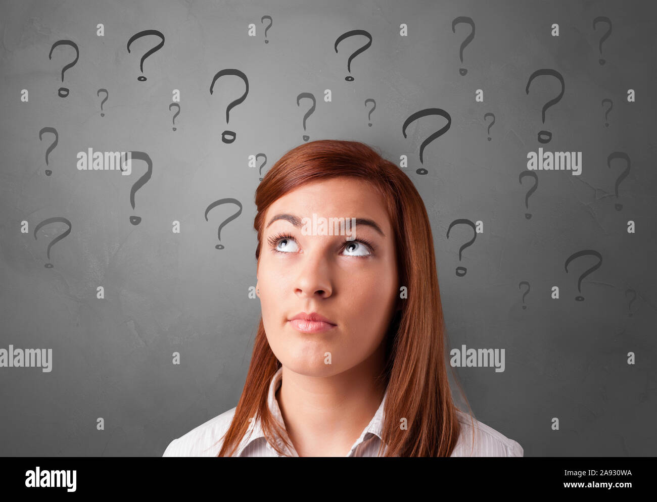Person with question marks around face Stock Photo - Alamy