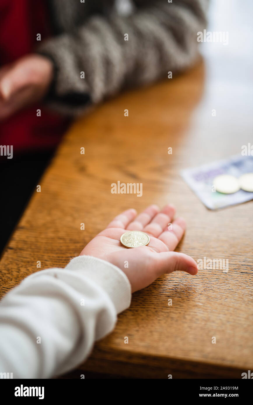 Hand holding coin Stock Photo - Alamy