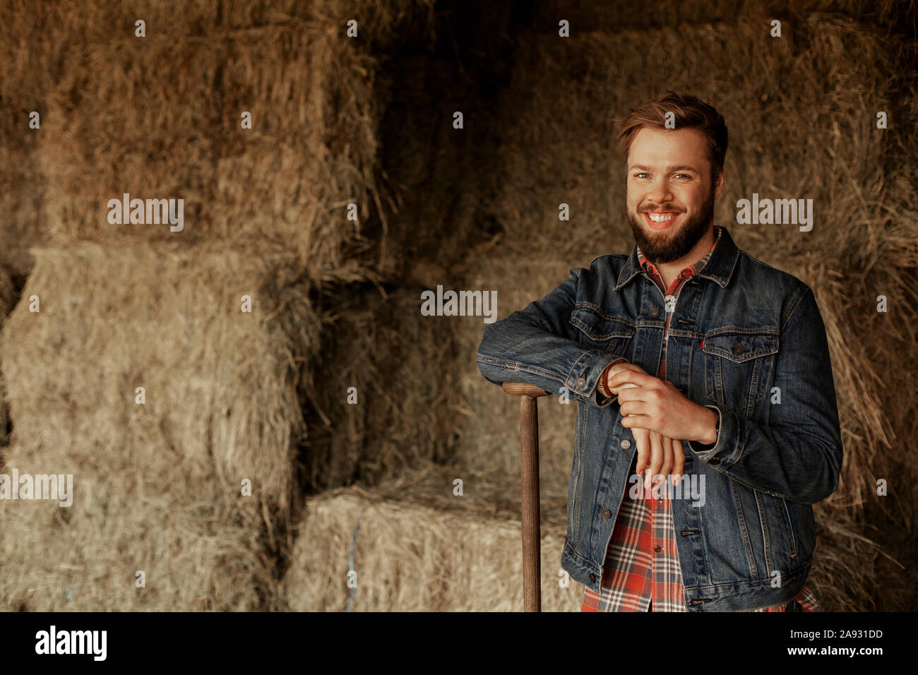 Smiling man in barn Stock Photo - Alamy