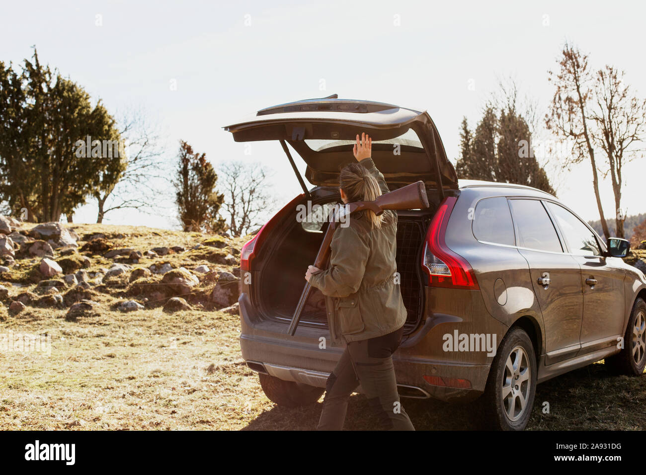 Woman standing by car hi-res stock photography and images - Alamy