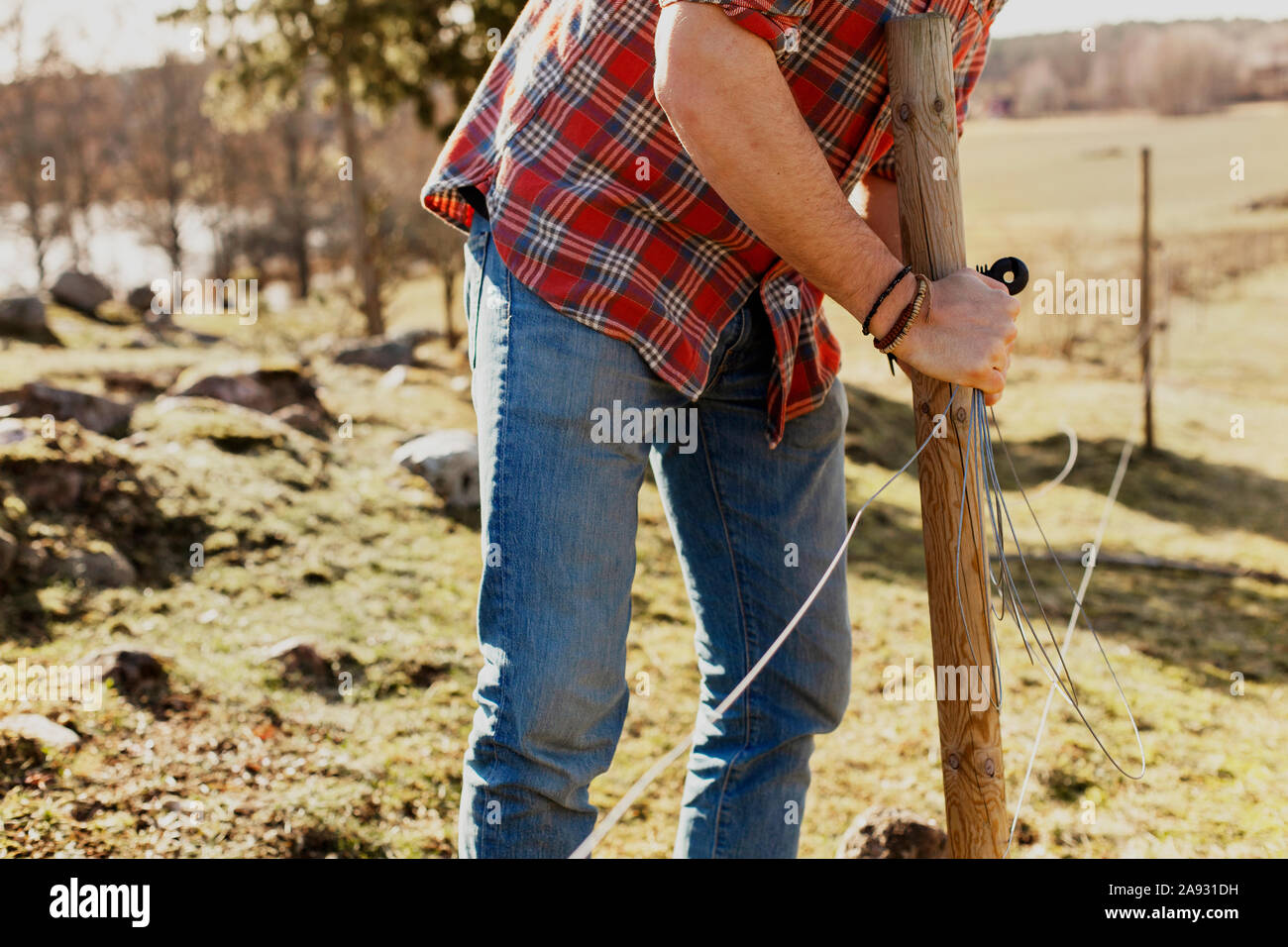 Man repairing fence Stock Photo - Alamy