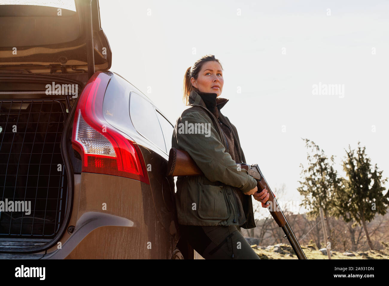 Woman standing by car hi-res stock photography and images - Alamy