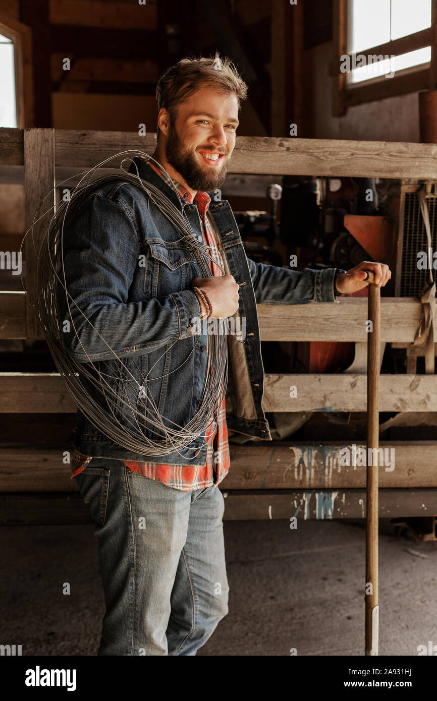 Smiling man in barn Stock Photo - Alamy