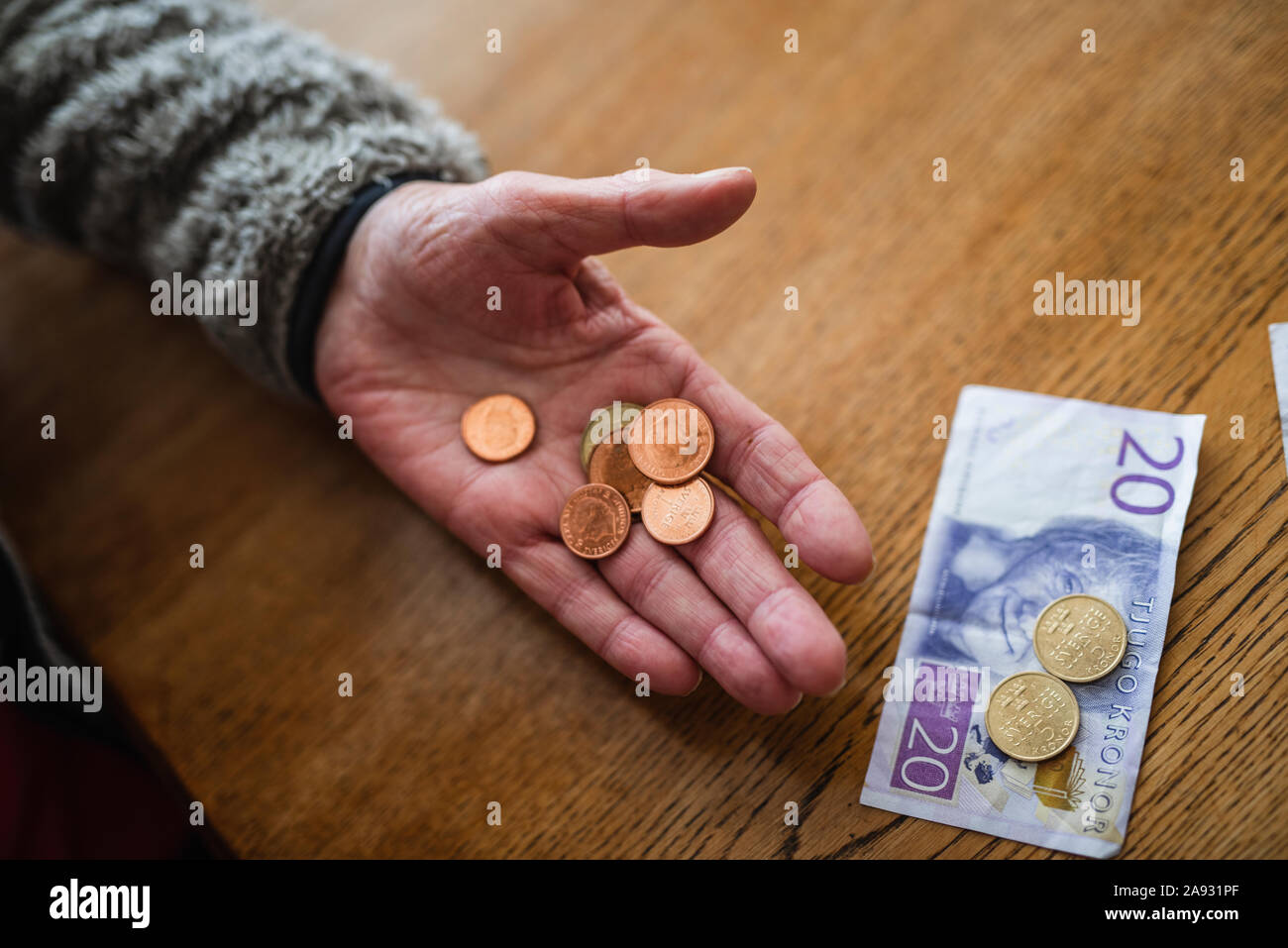Hand holding coins Stock Photo - Alamy