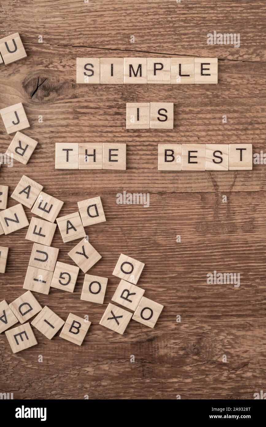 Simple is the best slogan written with cube letters on wooden ...