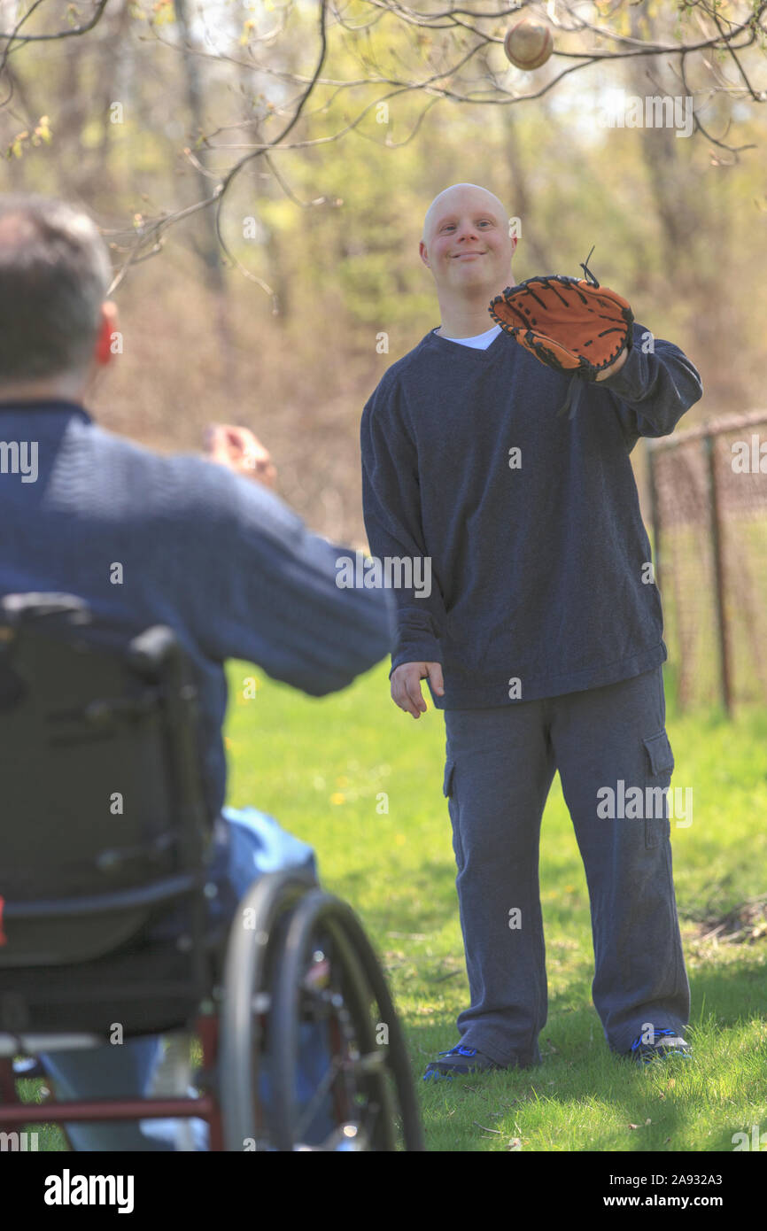 Father with Spinal Cord Injury and his son with Down Syndrome playing ...