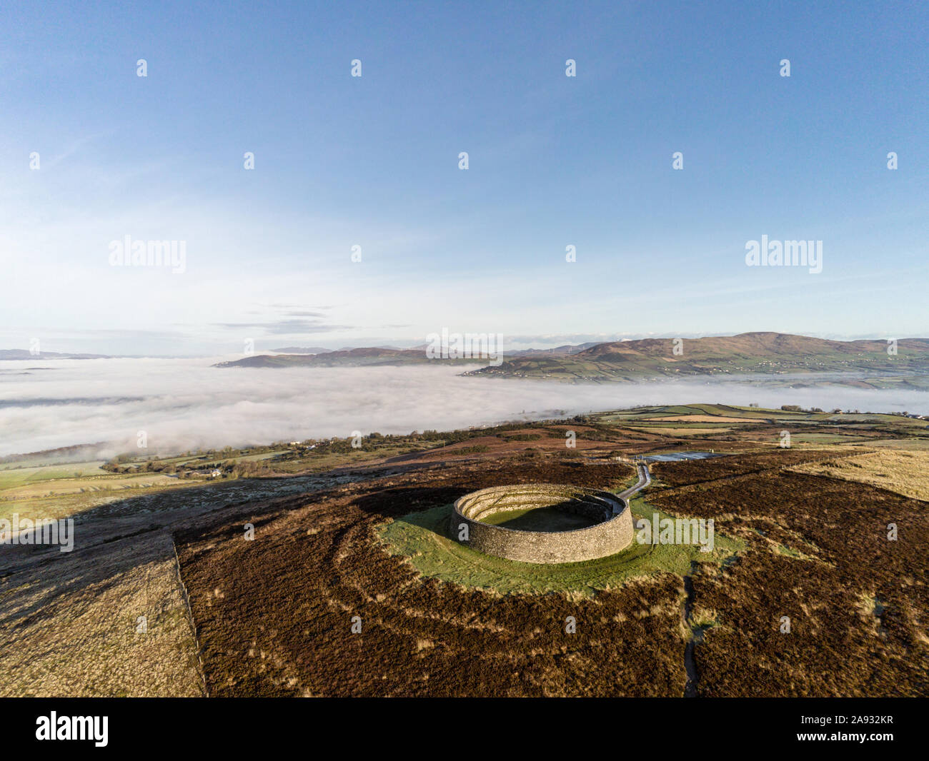 This is an aerial picture of Grianan Of Aileach with fog covering the ...