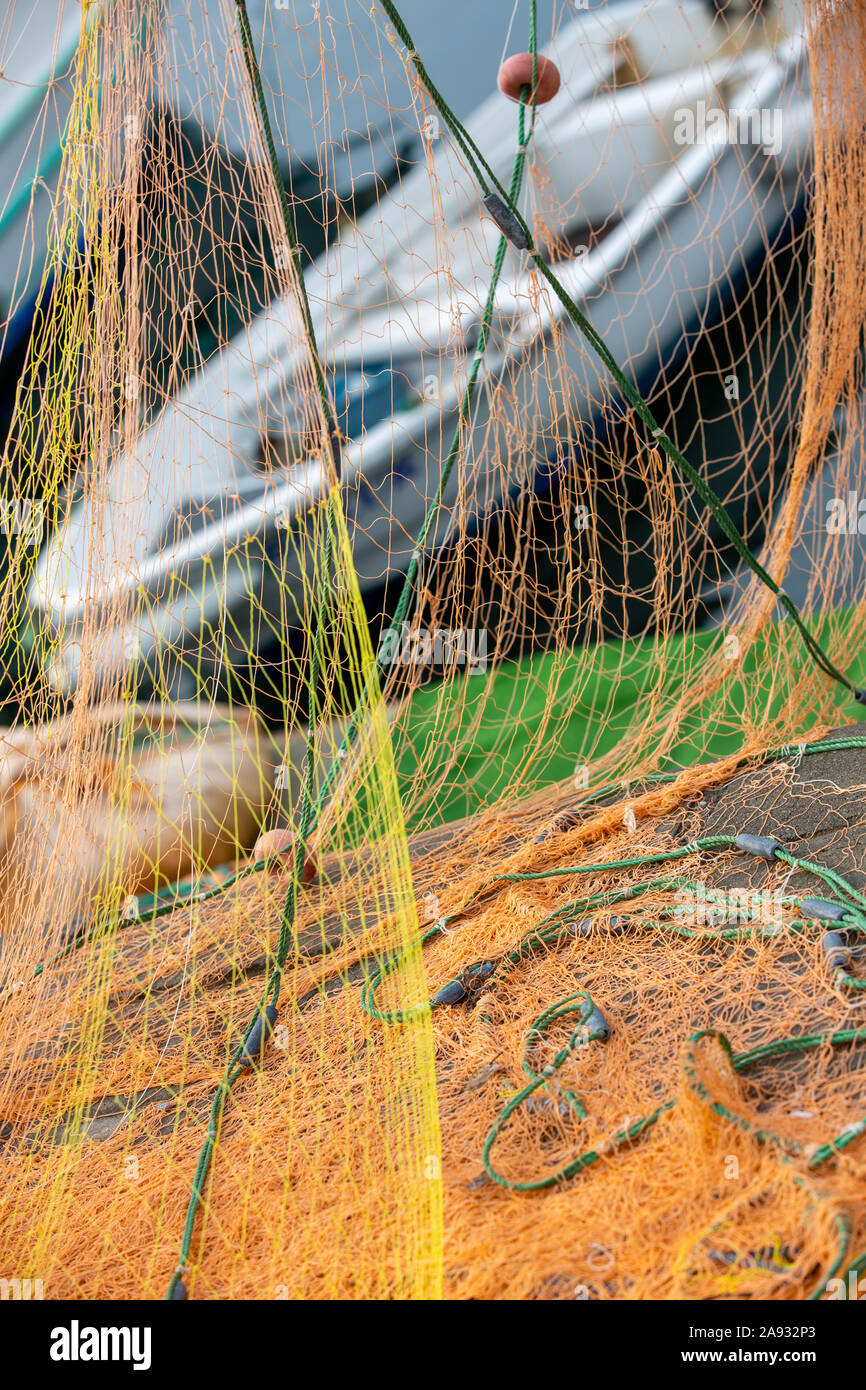 yellow fishing net is drying on pier after day of fishing. The white ...