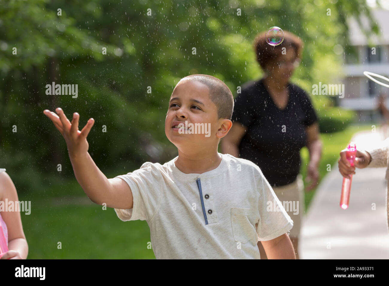 Hispanic boy with Autism playing outside with his family Stock Photo ...