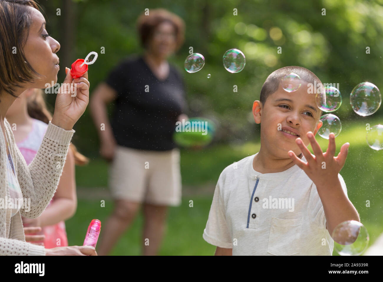 Hispanic boy with Autism playing outside with his family Stock Photo ...