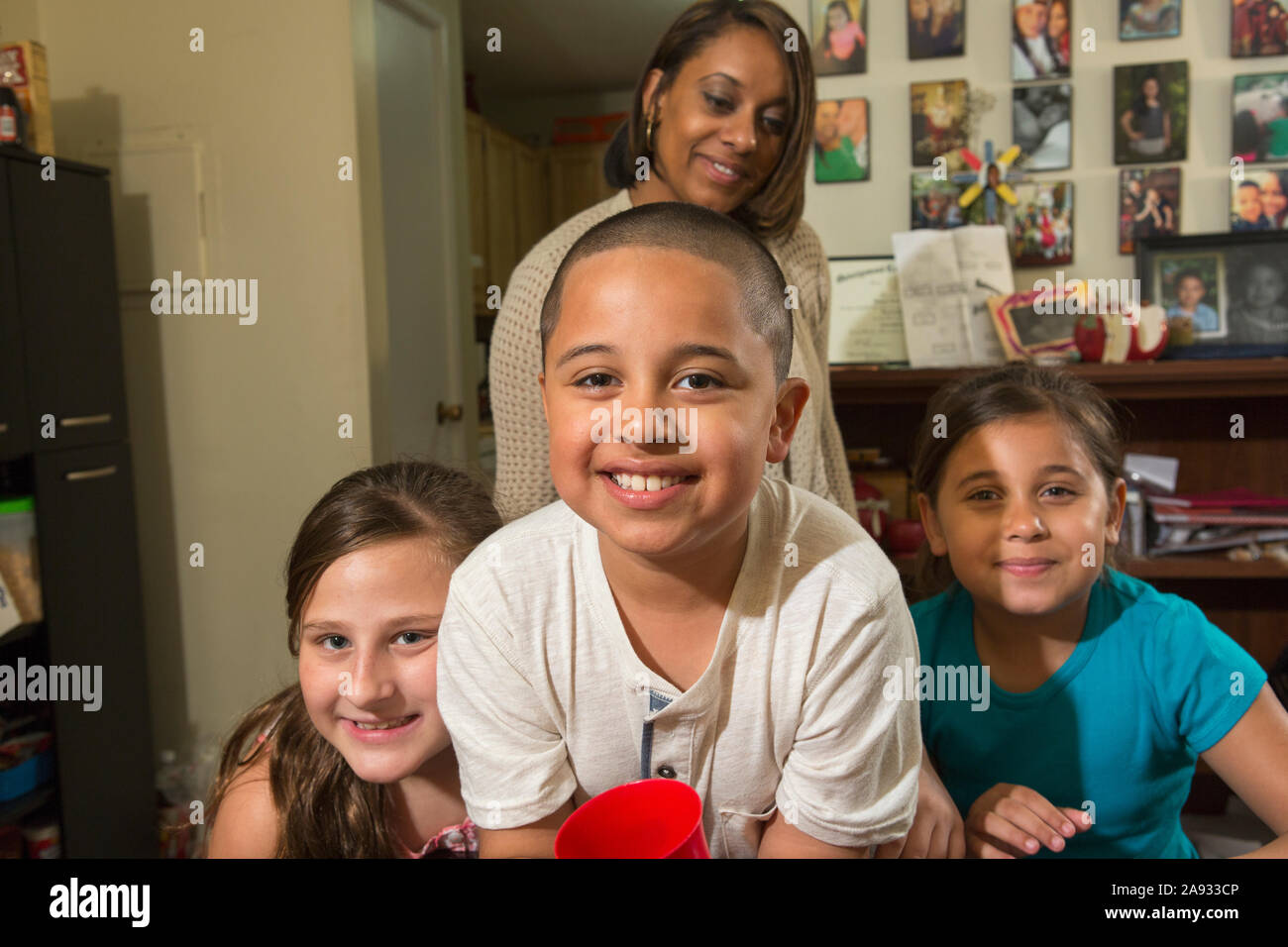 Hispanic boy with Autism with his mother and sisters at home Stock ...