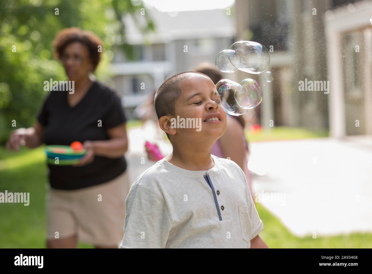 Hispanic boy with Autism playing outside with his family Stock Photo ...