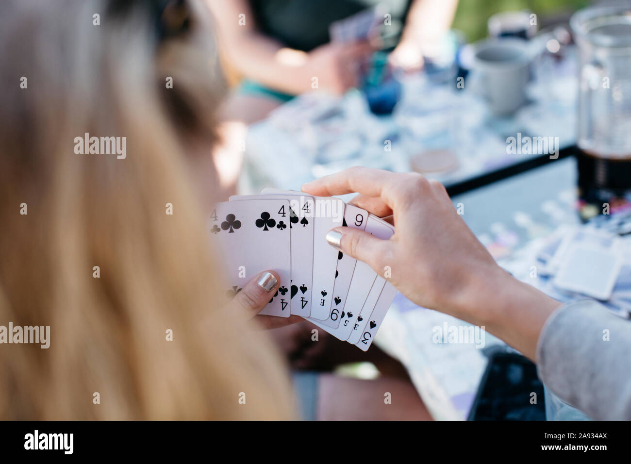 Woman playing cards Stock Photo - Alamy