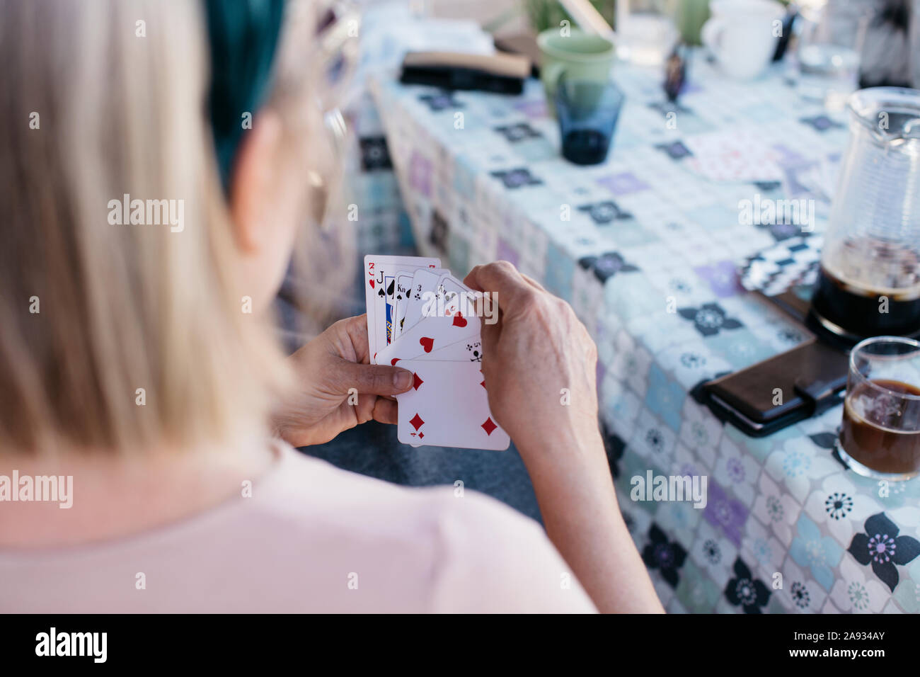 Woman playing cards Stock Photo - Alamy